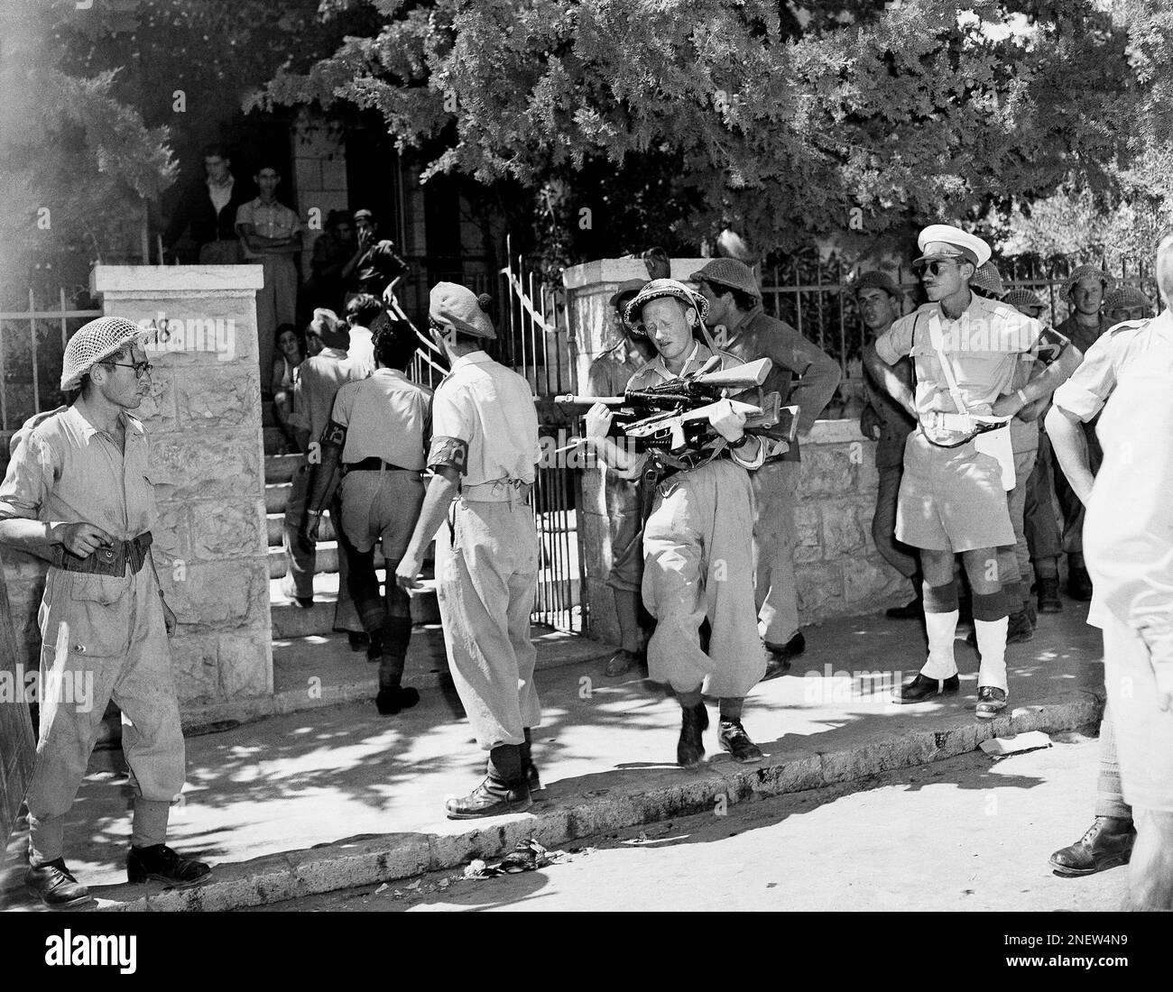 Israeli soldier takes arms from the Irgun armoury with at back Israeli ...