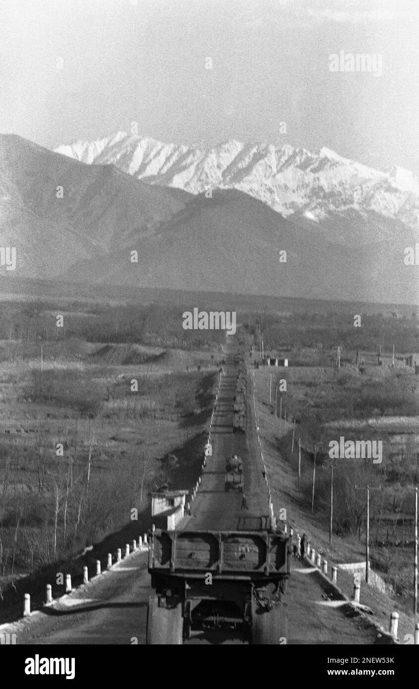 A long line of Soviet military trucks makes its way north toward the ...
