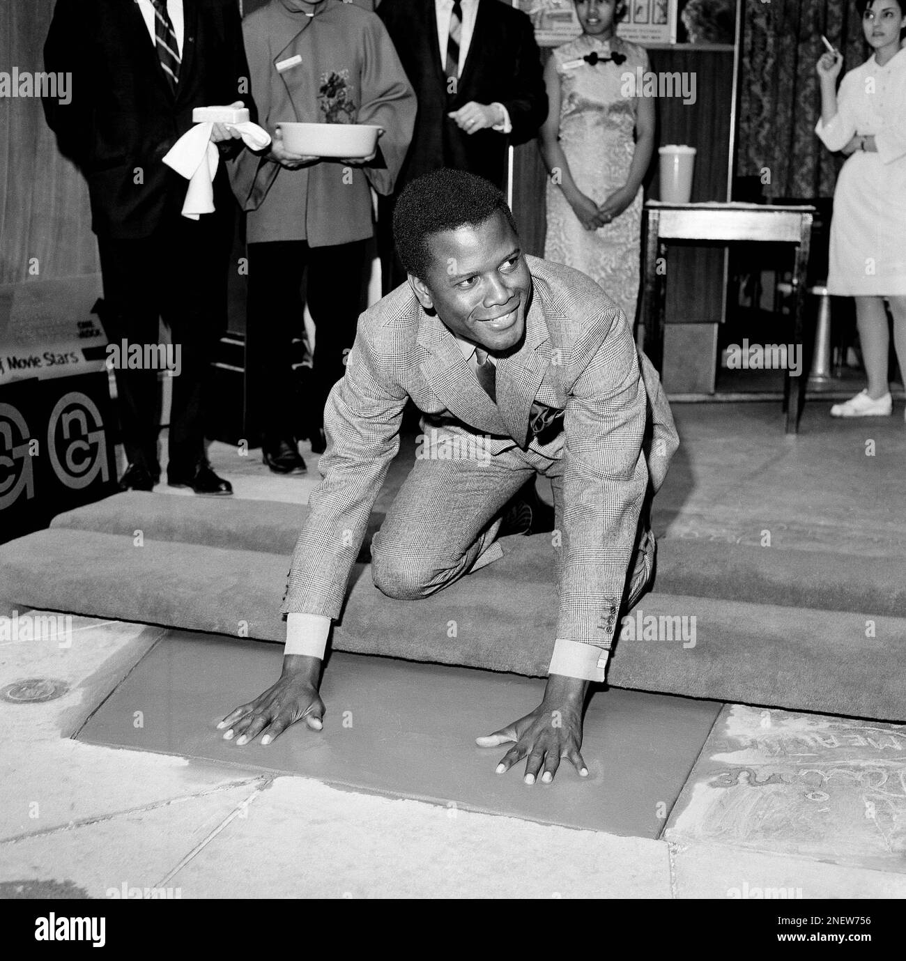 Actor Sidney Poitier inscribes his signature in wet cement at Grauman’s ...