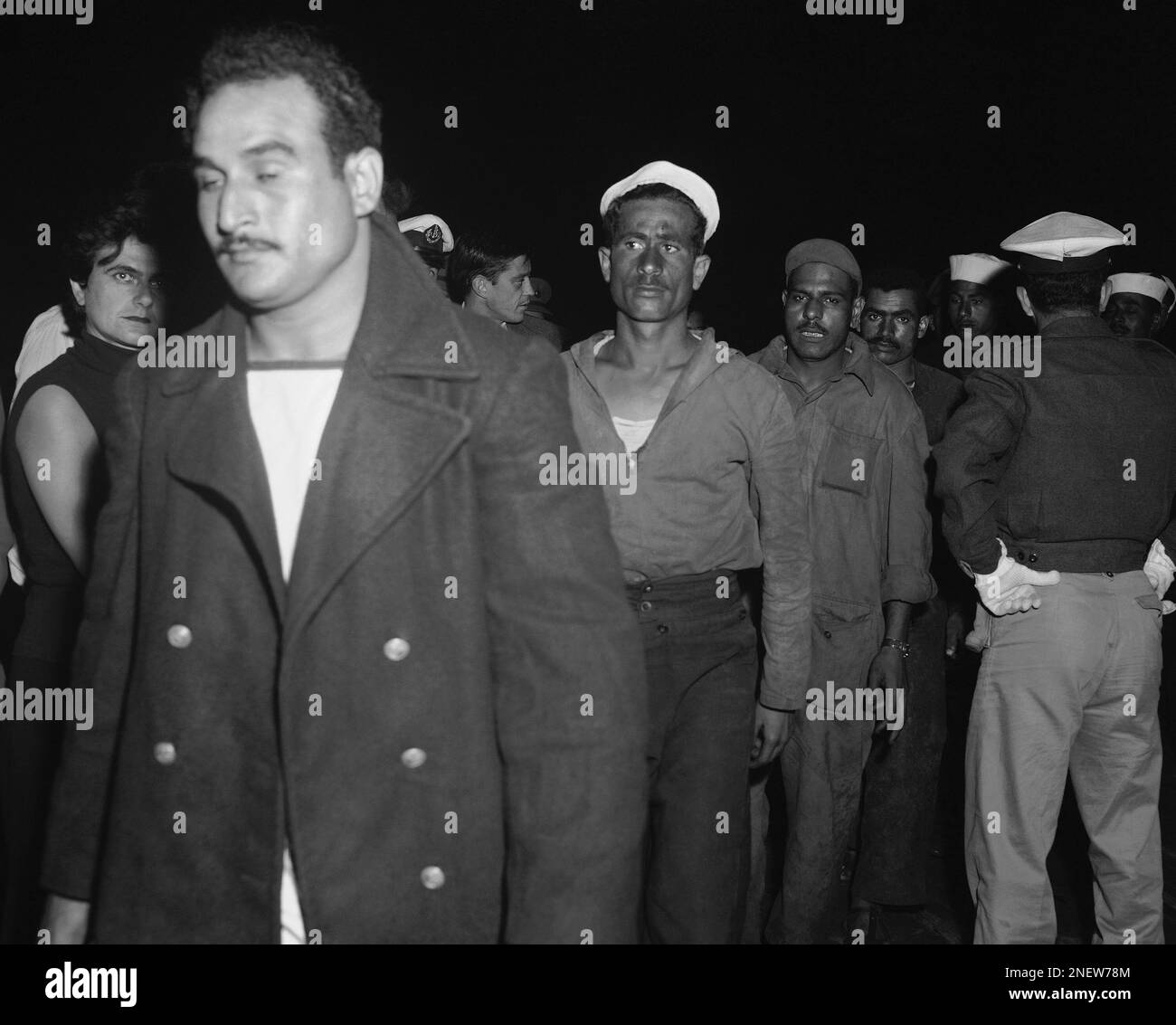 Dejected looking Egyptian sailors walk in single file in Haifa, Israel ...