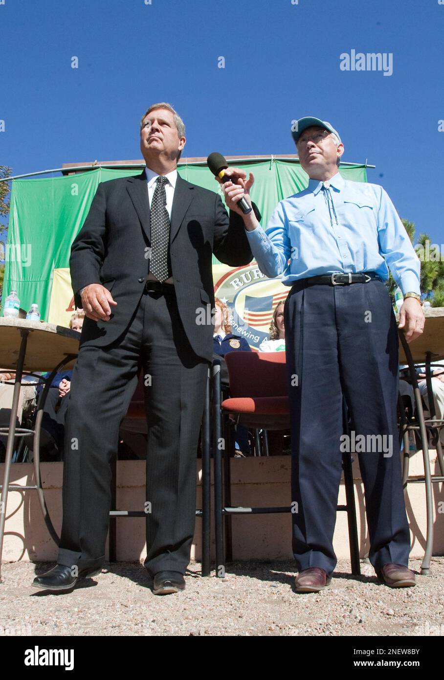 Agriculture Tom Vilsack, left, takes the microphone from Sec. of the ...