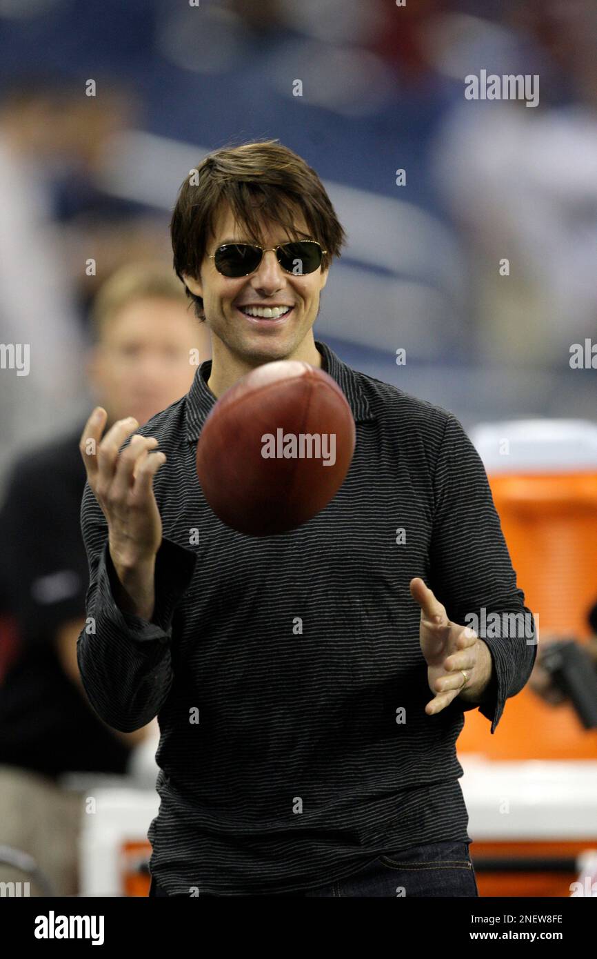 Actor Tom Cruise spins a football before the Washington Redskins ...