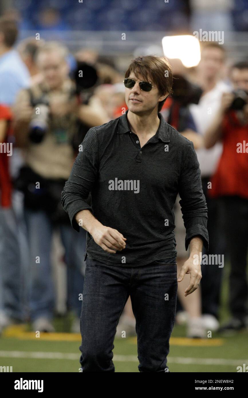 Actor Tom Cruise walks the sidelines before the Washington Redskins ...