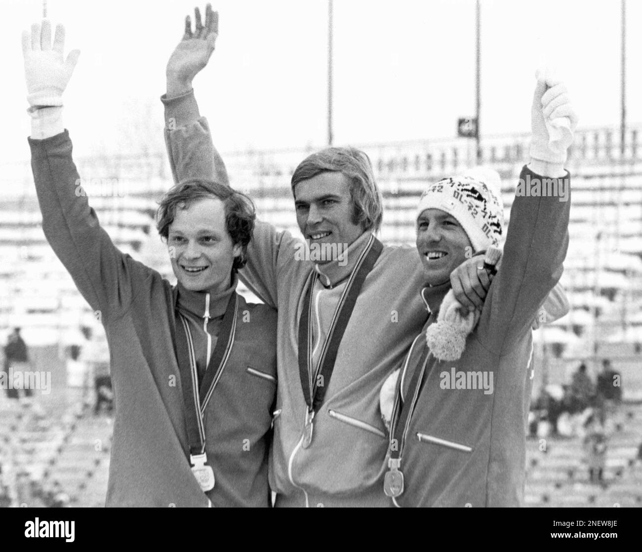 Three medalist of Olympic 5000 meter speed skate wave with medals after presentation ceremony ...