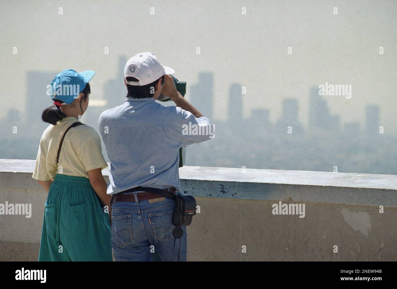 Two Japanese tourists view downtown Los Angeles from the Griffith ...