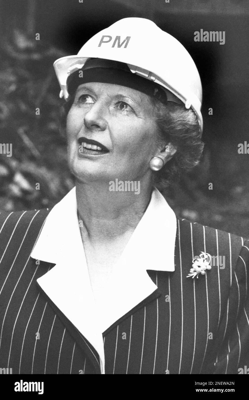 Prime Minister Mrs. Margaret Thatcher wears a safety hat with the ...