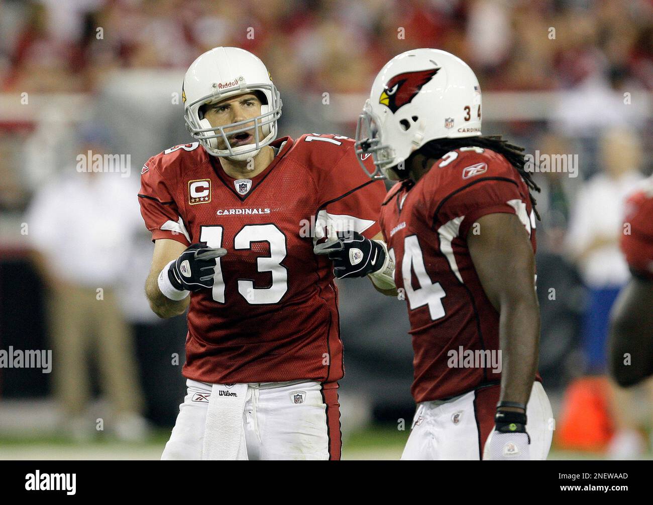 Arizona Cardinals' Kurt Warner (13) tries to give direction to teammate ...