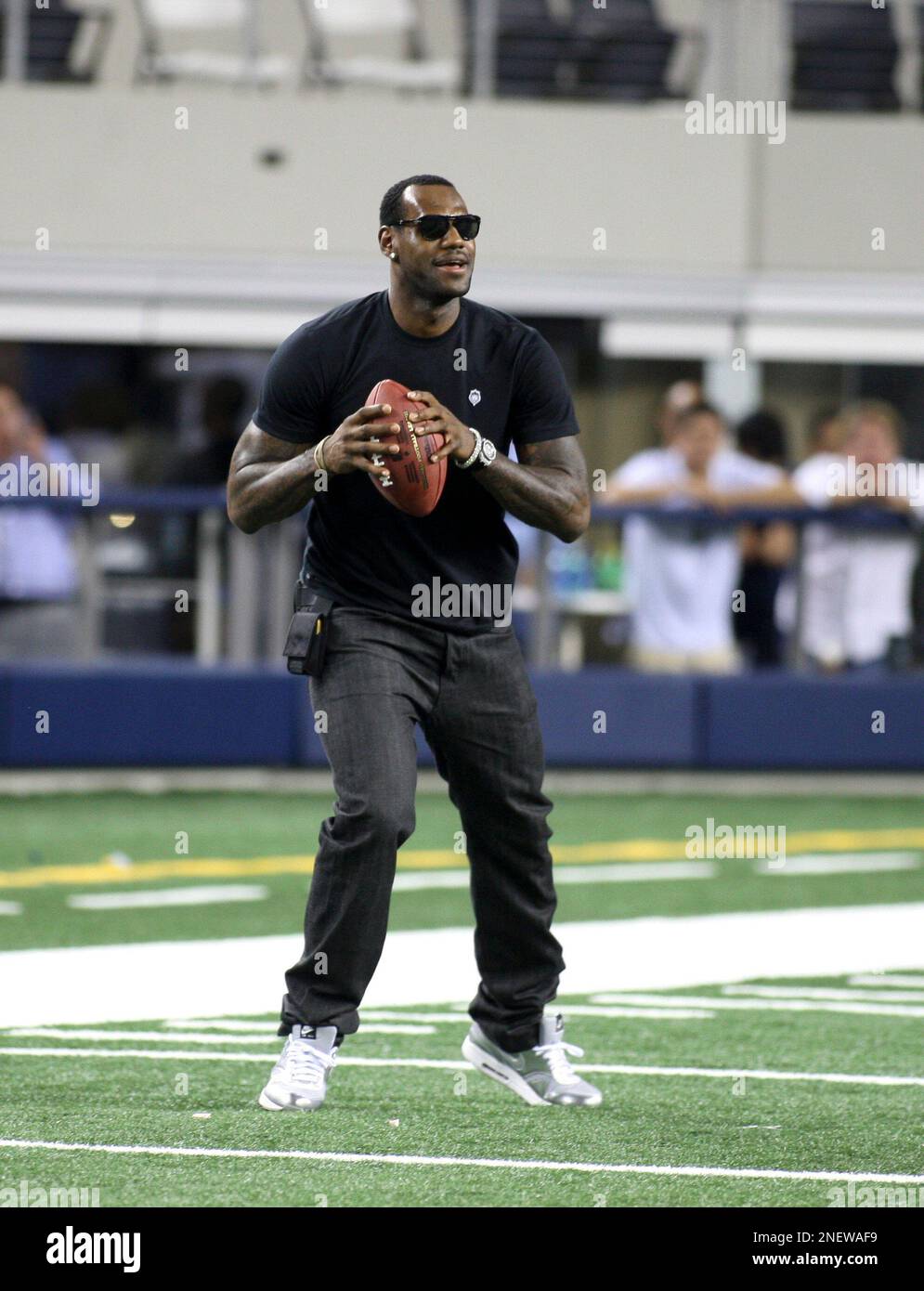 NBA star LeBron James plays catch on the field following an NFL ...