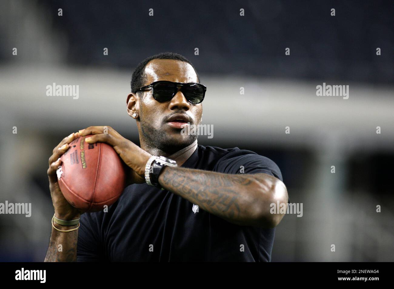 NBA star LeBron James plays catch on the field following an NFL ...