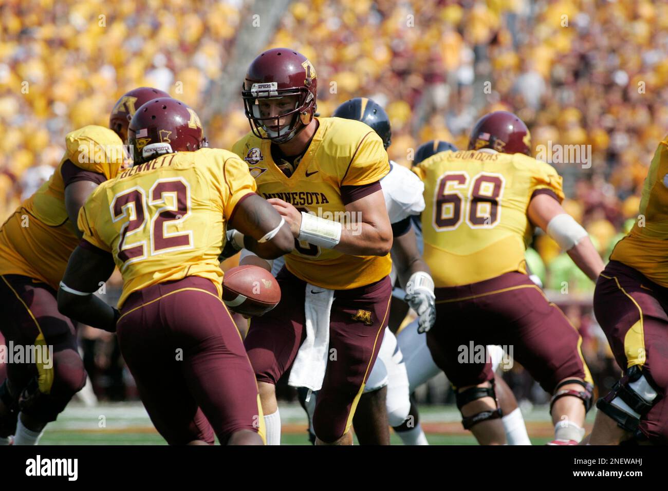 Minnesota quarterback Adam Weber (8) hands-off to running back Duane ...