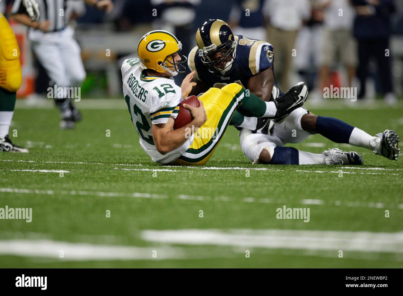 Green Bay Packers quarterback Aaron Rodgers, left, is sacked by St ...