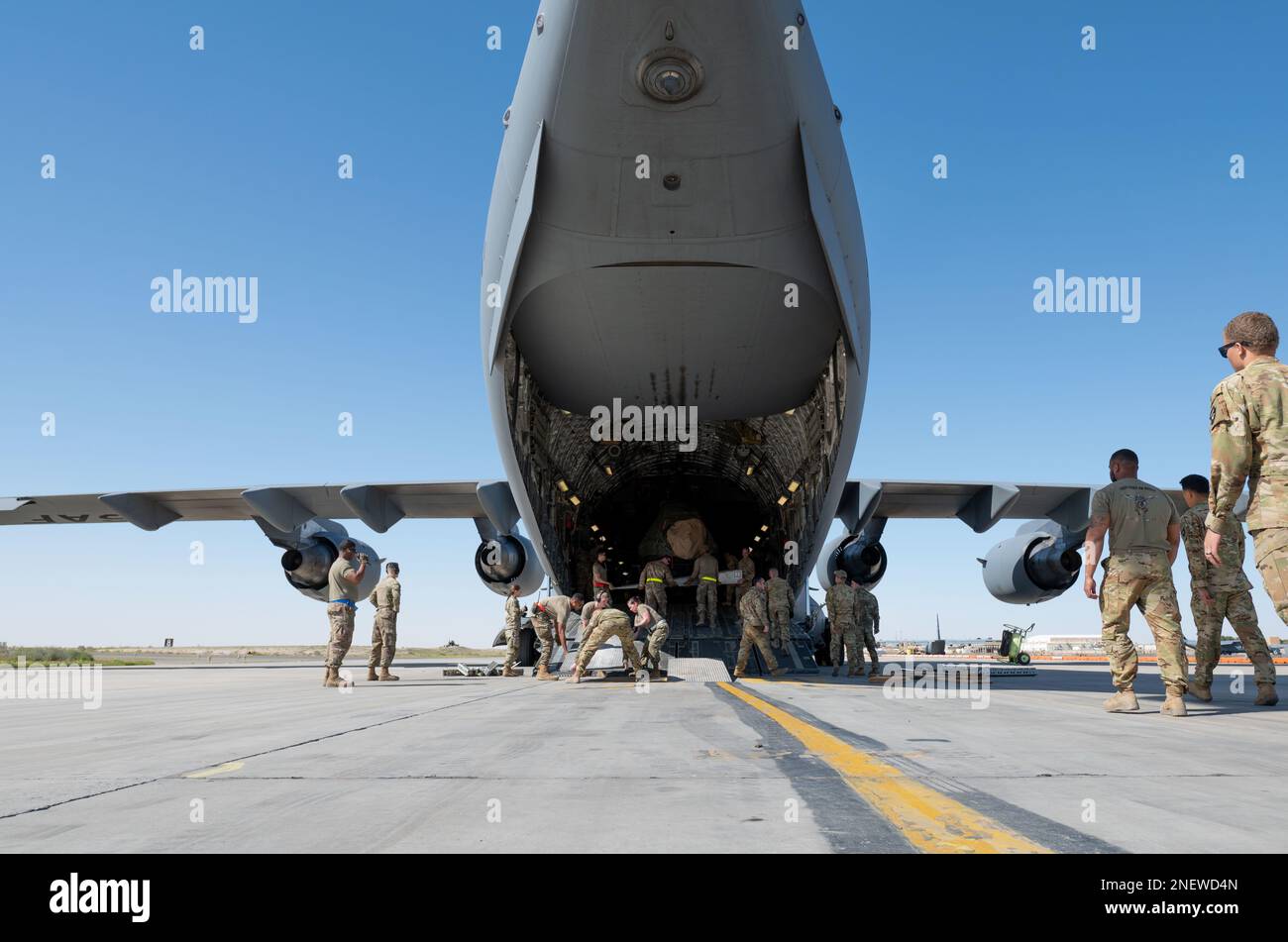U.S. Airmen and Soldiers offload an AH-64D Apache Longbow helicopter ...