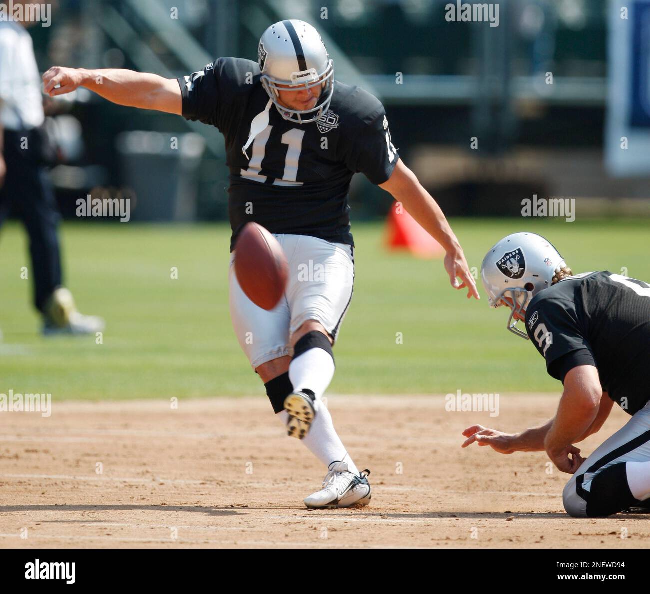 Oakland Raiders PK Sebastian Janikowski (11) kicks as punter Shane ...