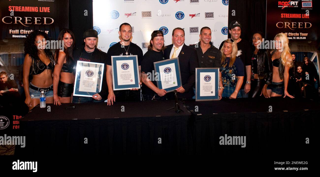 Center - Creed bassist Brian Marshall, guitarist Mark Tremonti, drummer ...