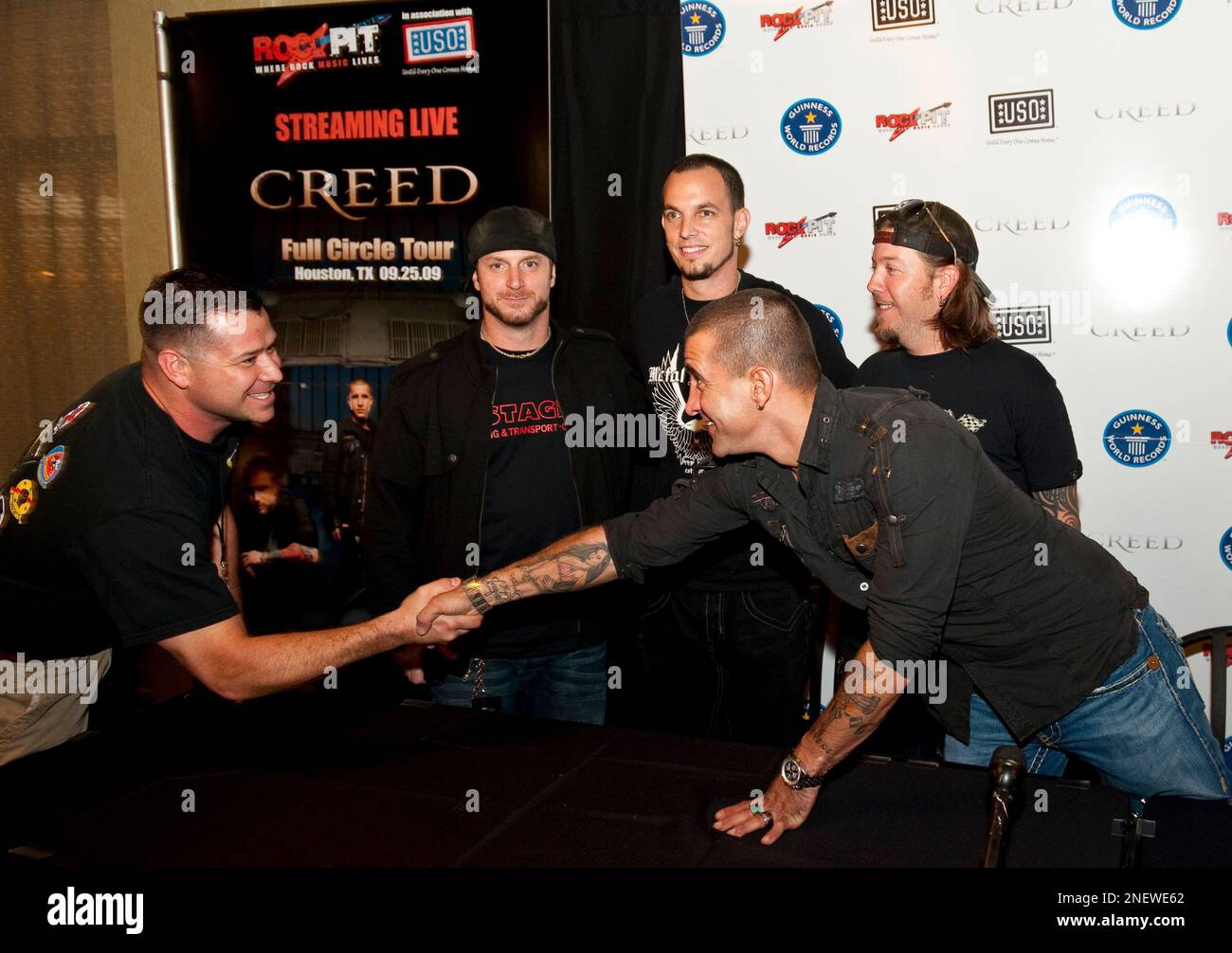 U.S. Navy Commander Jerry Brown, left, shakes hands with Creed lead ...