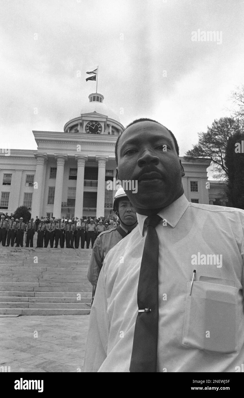 A solid line of state troopers stands shoulder to shoulder on steps of ...