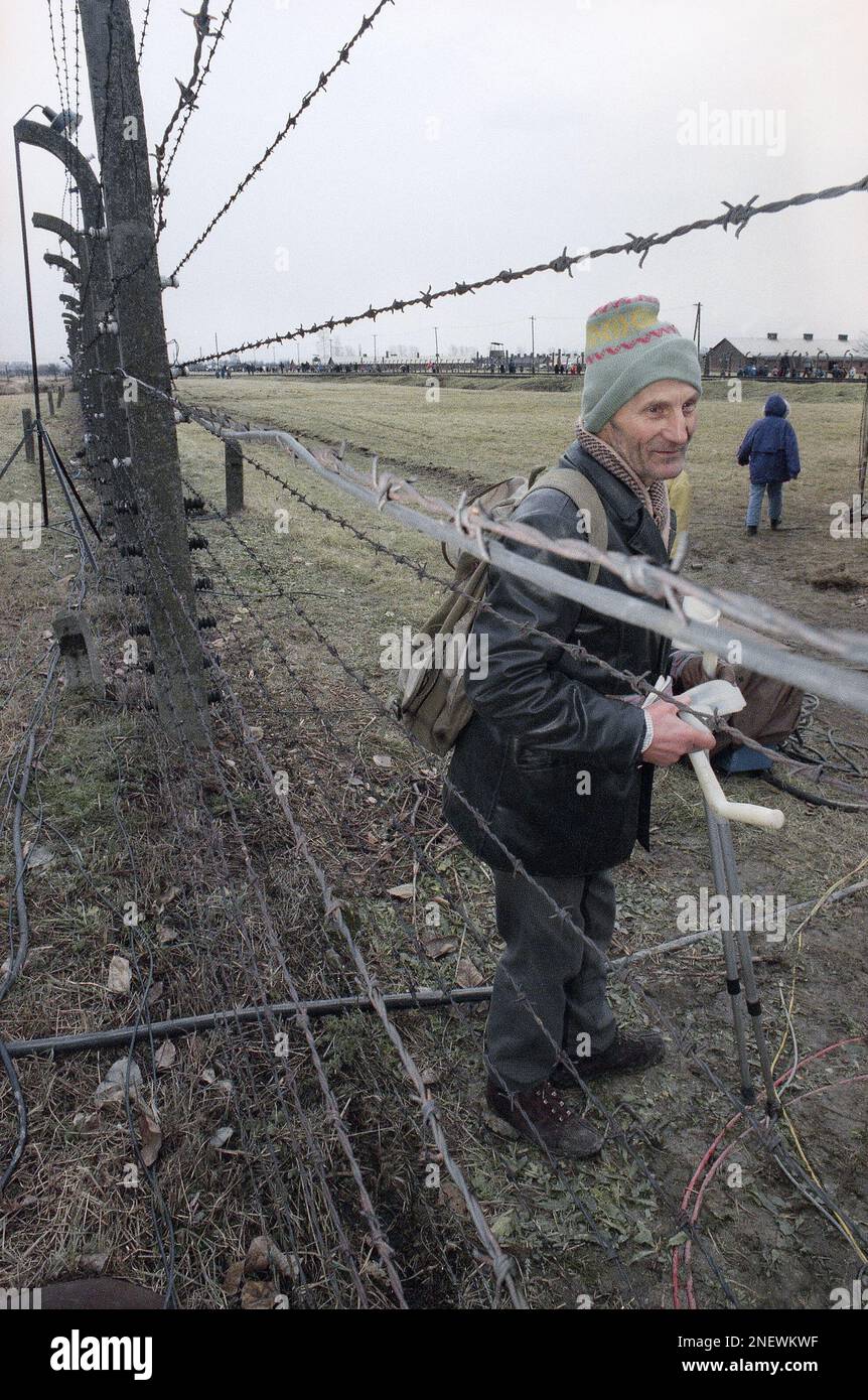 Ludwig Bogooz, from Poland, stands behind the barbed wire of the one ...