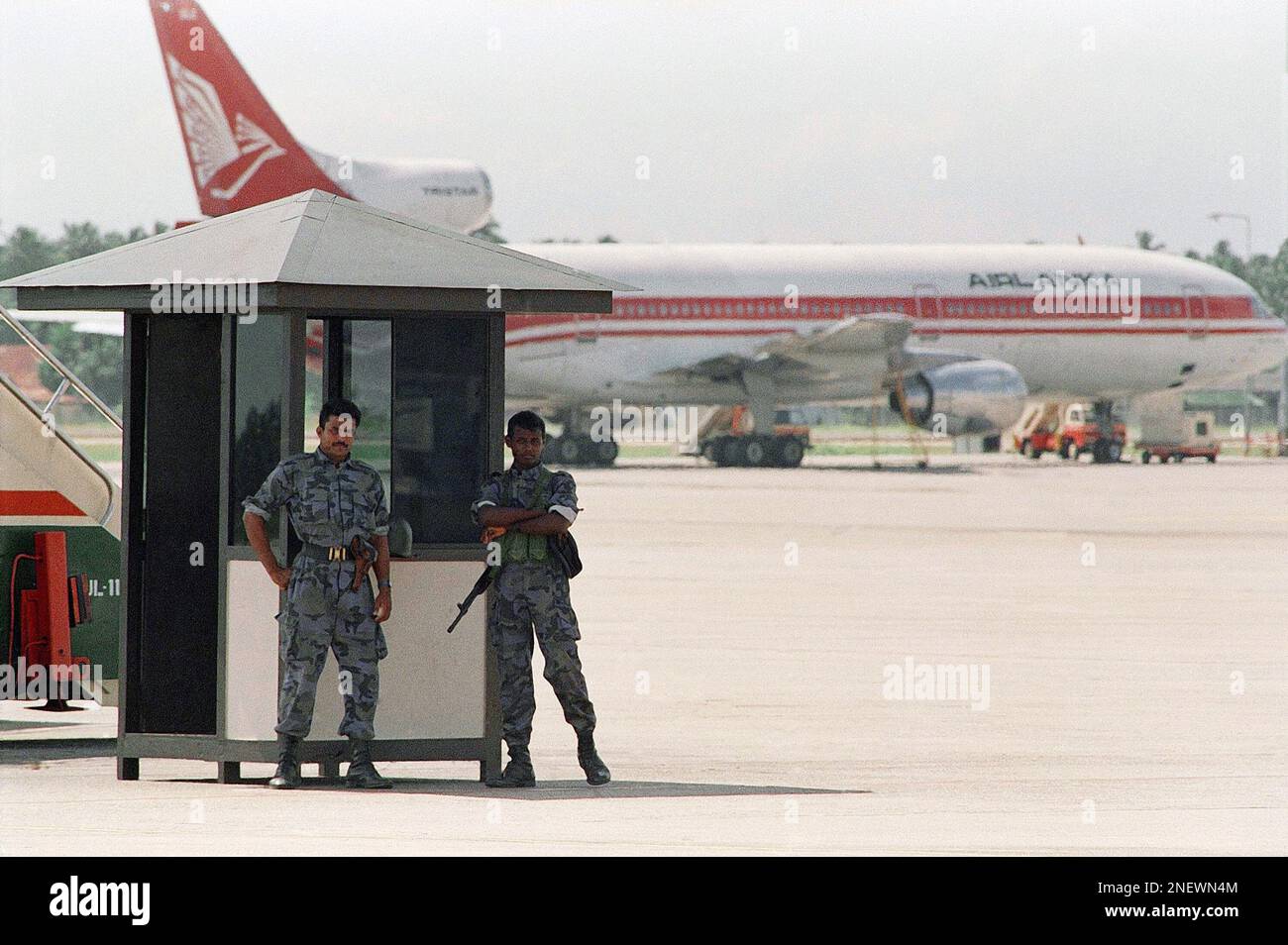 Armed soldiers on guard on the tarmac of the Colombo airport, Monday ...