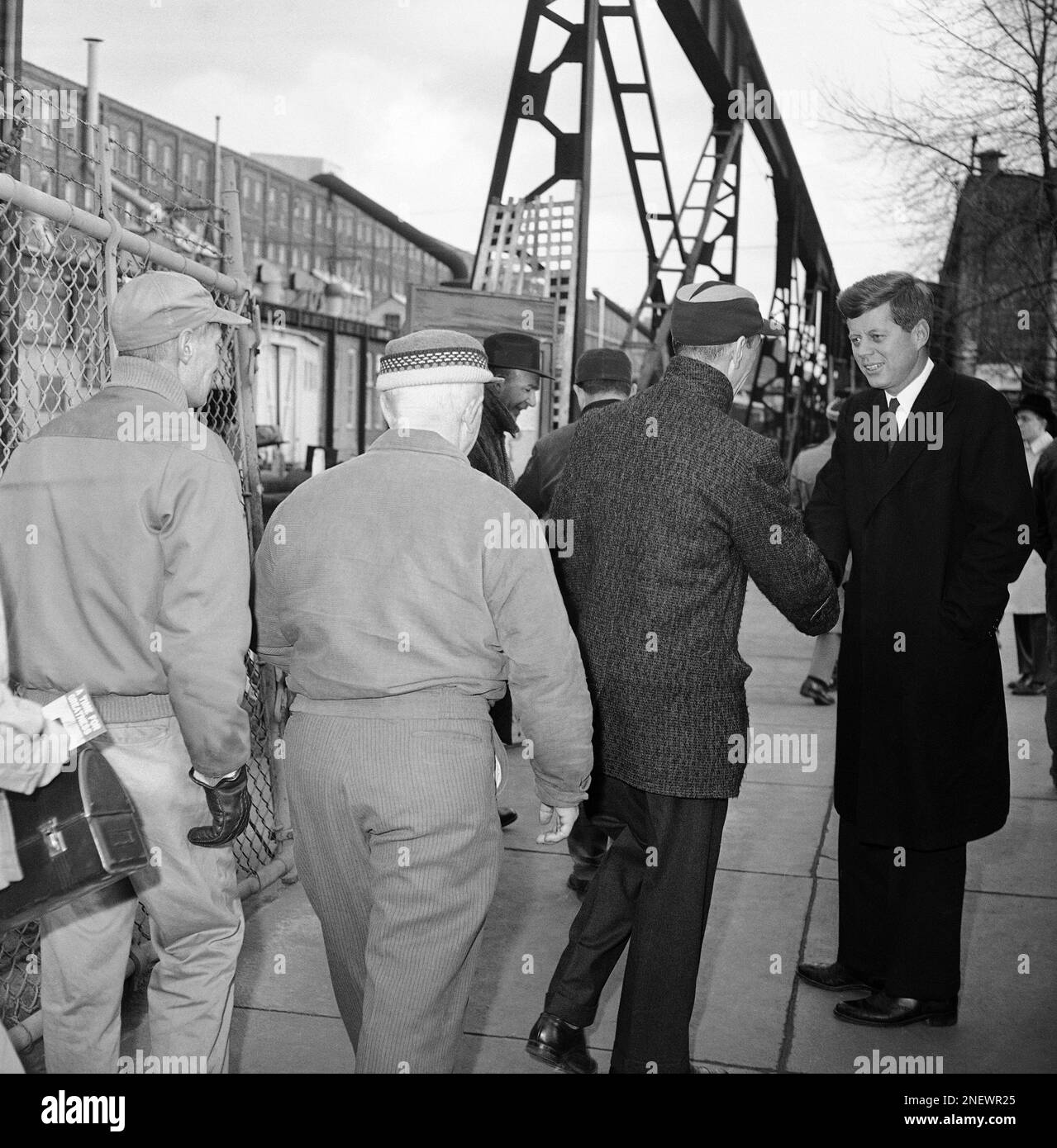 Workmen find Sen. John F. Kennedy greeting them at gate to Allis ...
