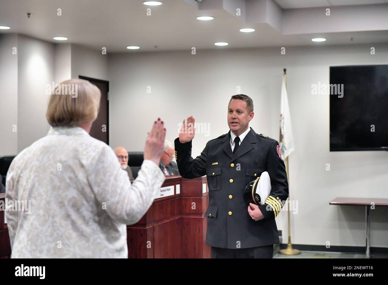 Streamwood, Illinois, USA. Newly promoted firefighter being sworn into ...