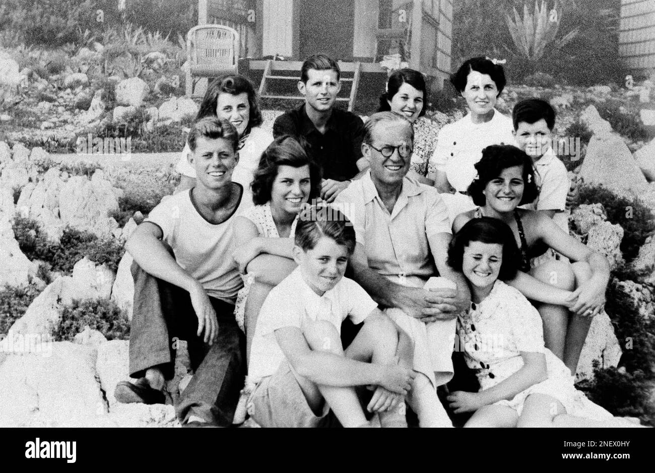 Joseph P. Kennedy, Sr., is shown surrounded by his family. Clockwise ...