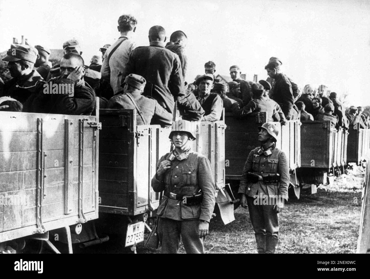 German soldiers guard Polish prisoners of war, crowded into rail trucks ...