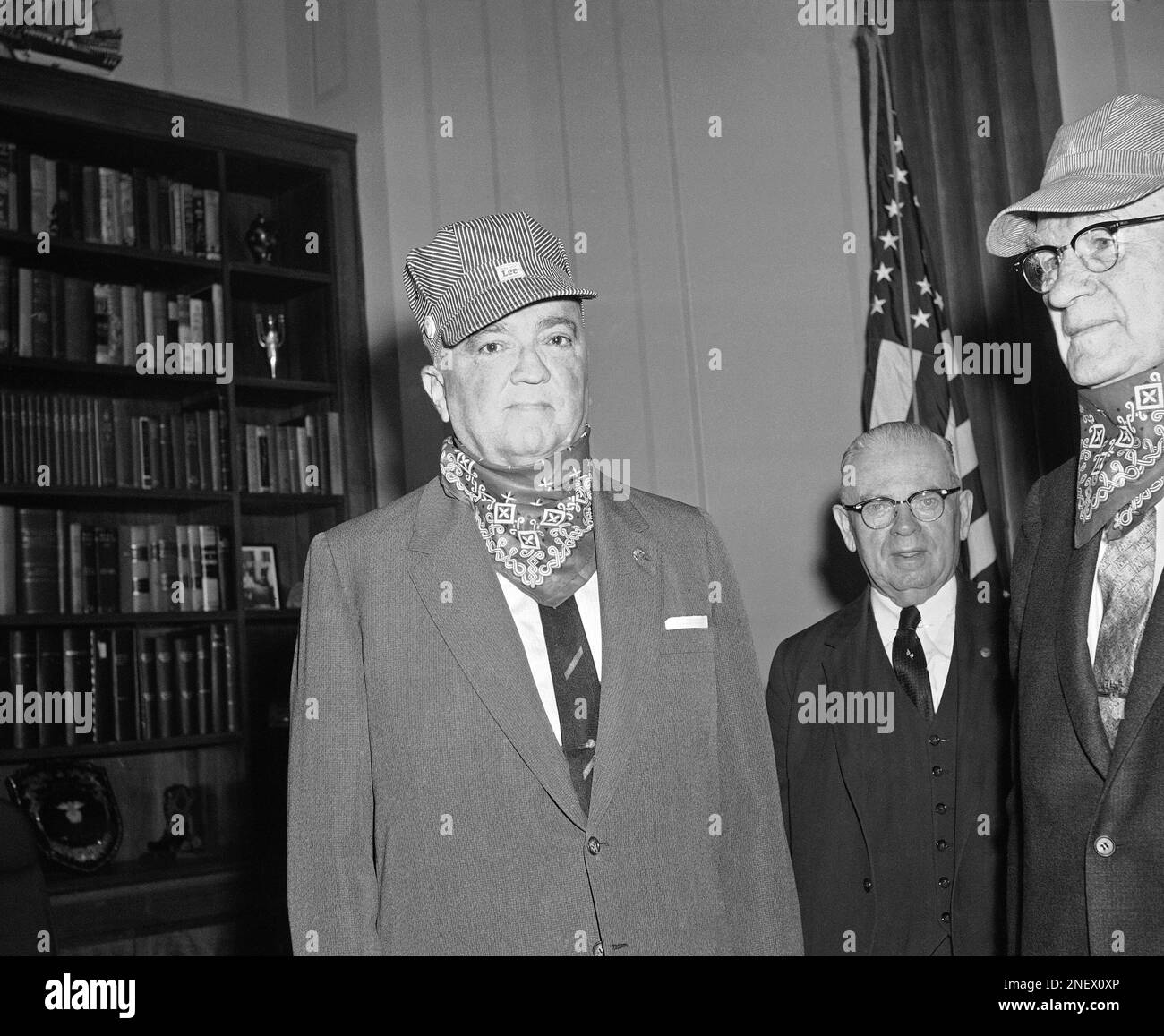 FBI Director J. Edgar Hoover wears the cap and kerchief of a locomotive ...