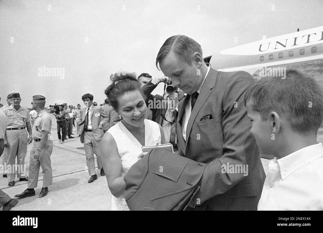 Apollo 11 astronaut Neil A. Armstrong autographs a notebook for Mrs ...