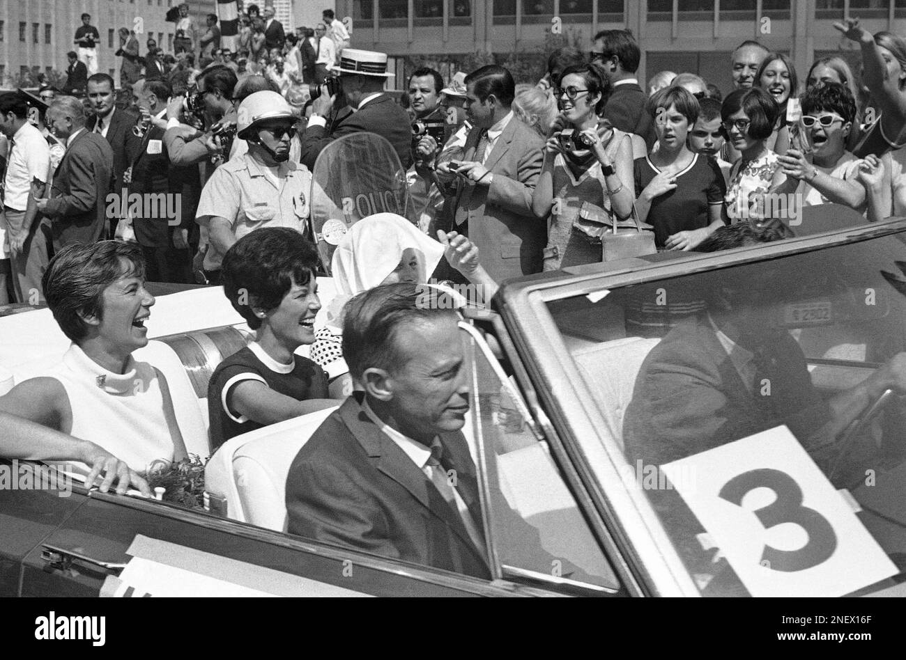 Having a ball as she rides in procession to honor her husband and ...