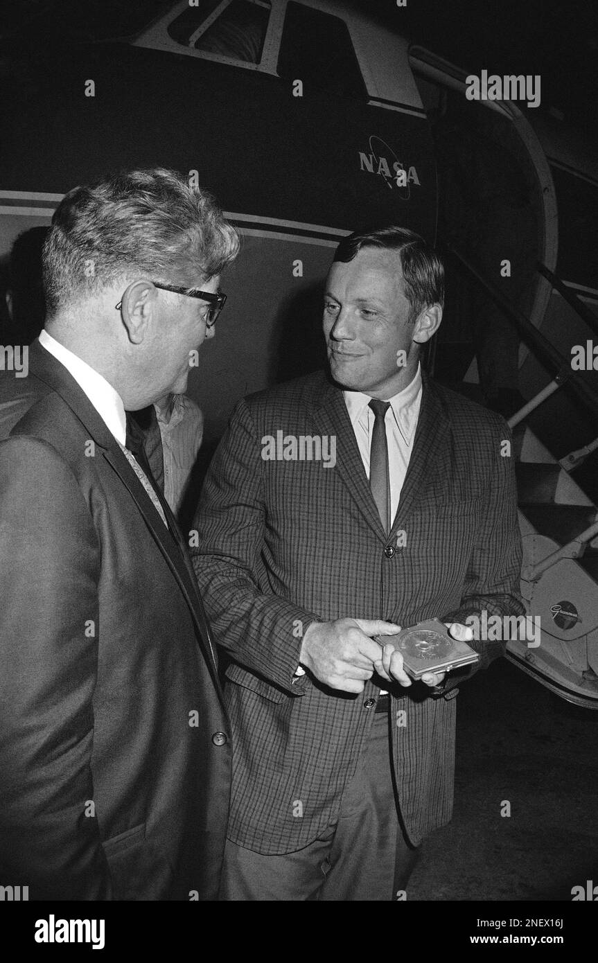 Astronaut and moon walker Neil Armstrong, right, accepts an medallion ...