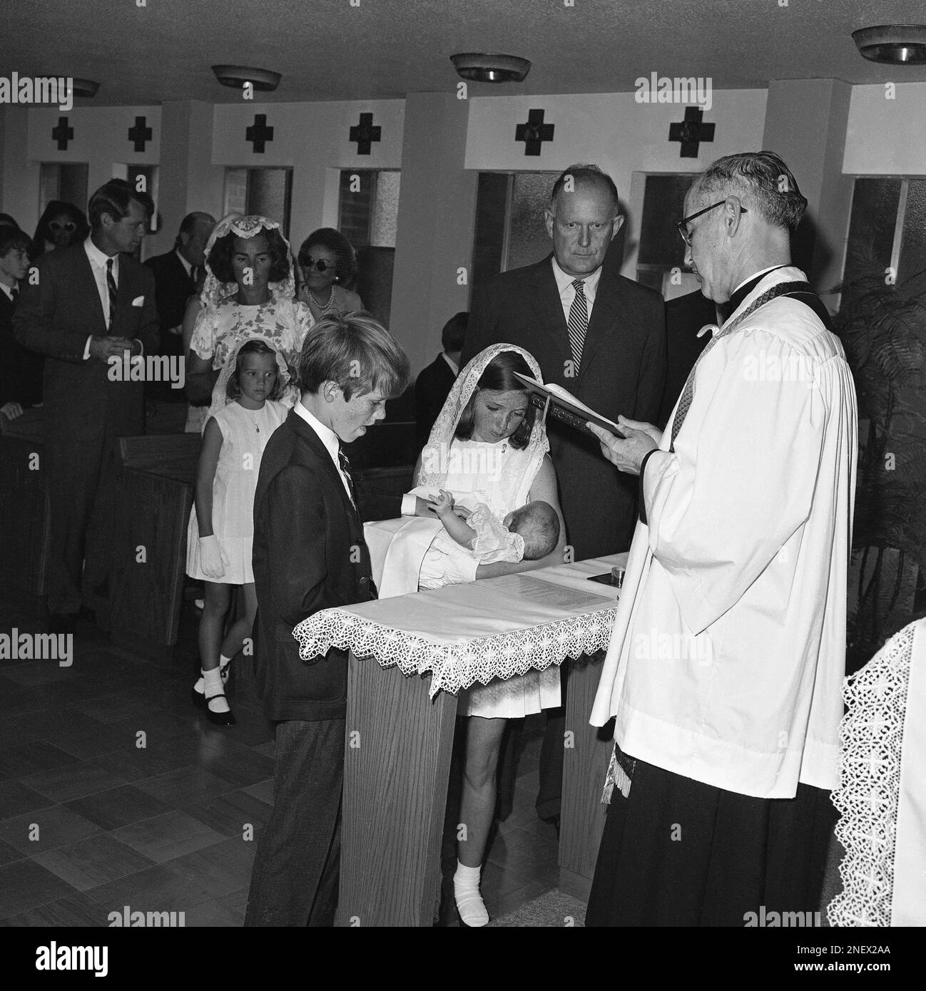 Father Albert Pereira presides over the rites of baptism for Douglas ...