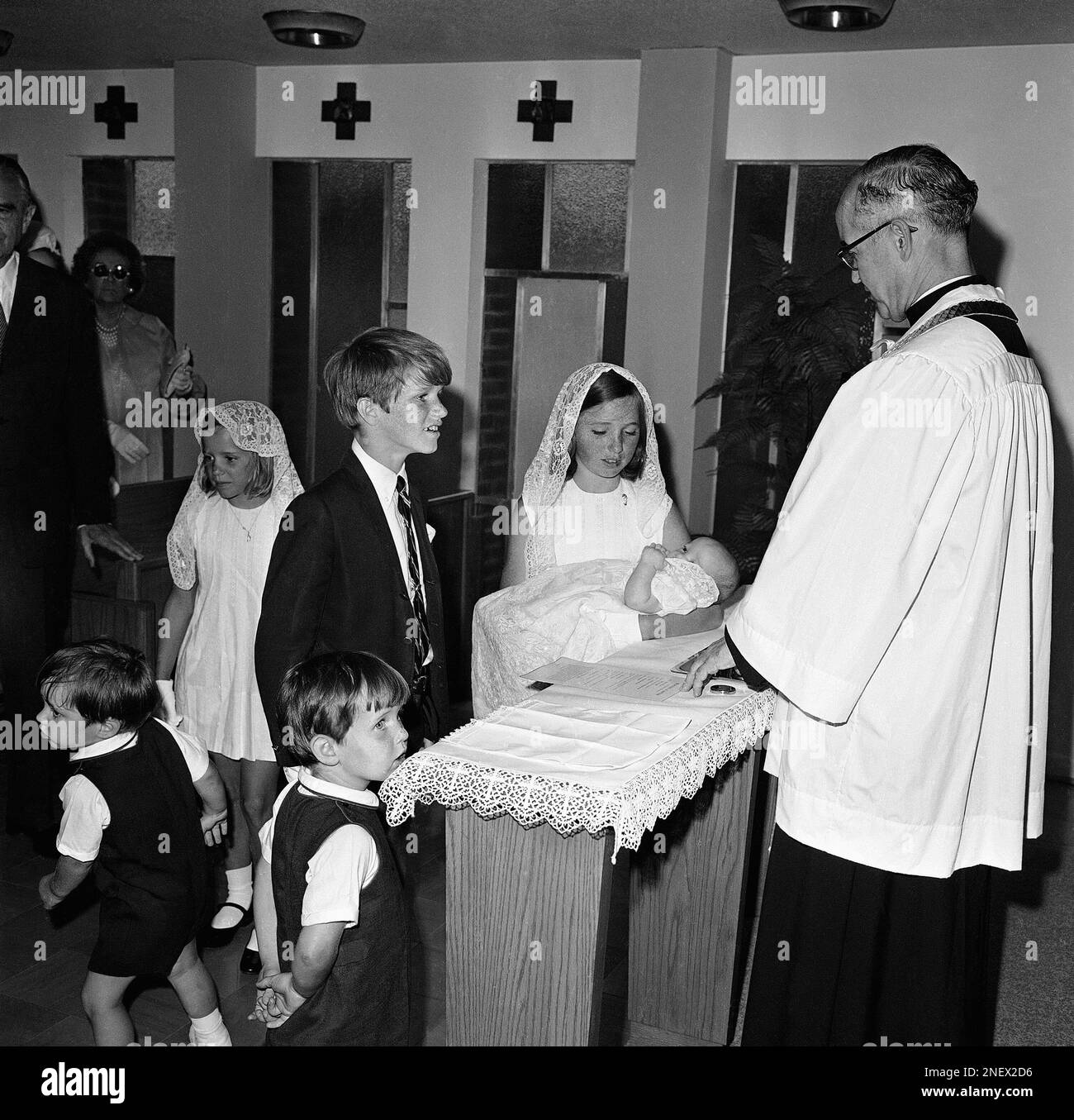 Father Albert Pereira presides over the rites of baptism to Douglas ...