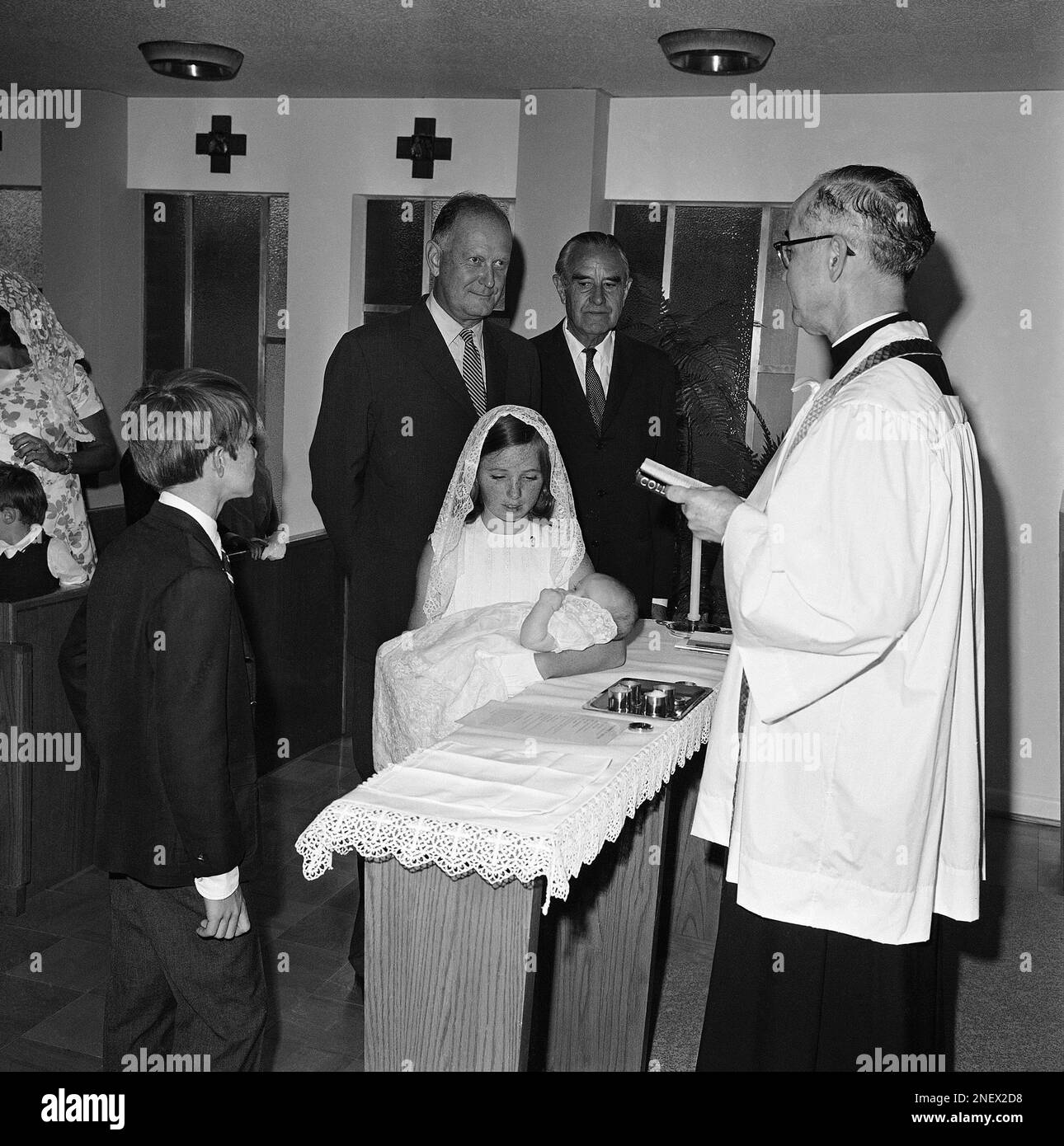 Father Albert Pereira presides over the rites of baptism to Douglas ...