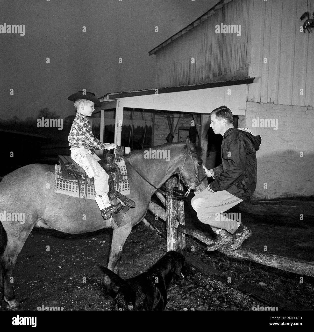 Robert Kennedy with Joseph Patrick, 7, on horse Toby with dog, Battle ...