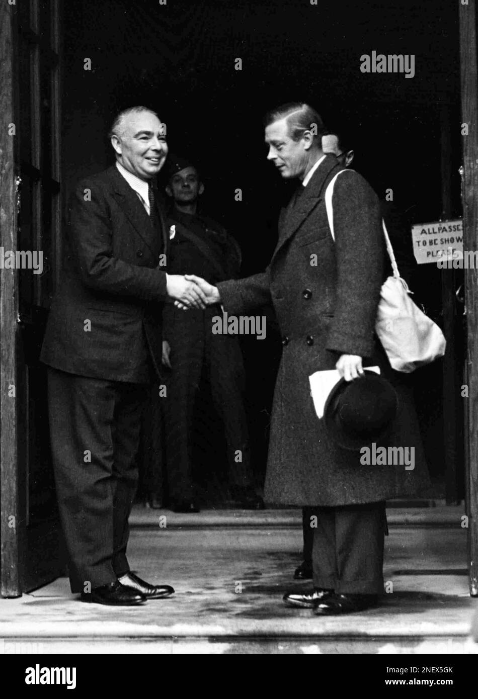 Britain's Duke of Windsor, right, with his gas mask on his back, shakes ...