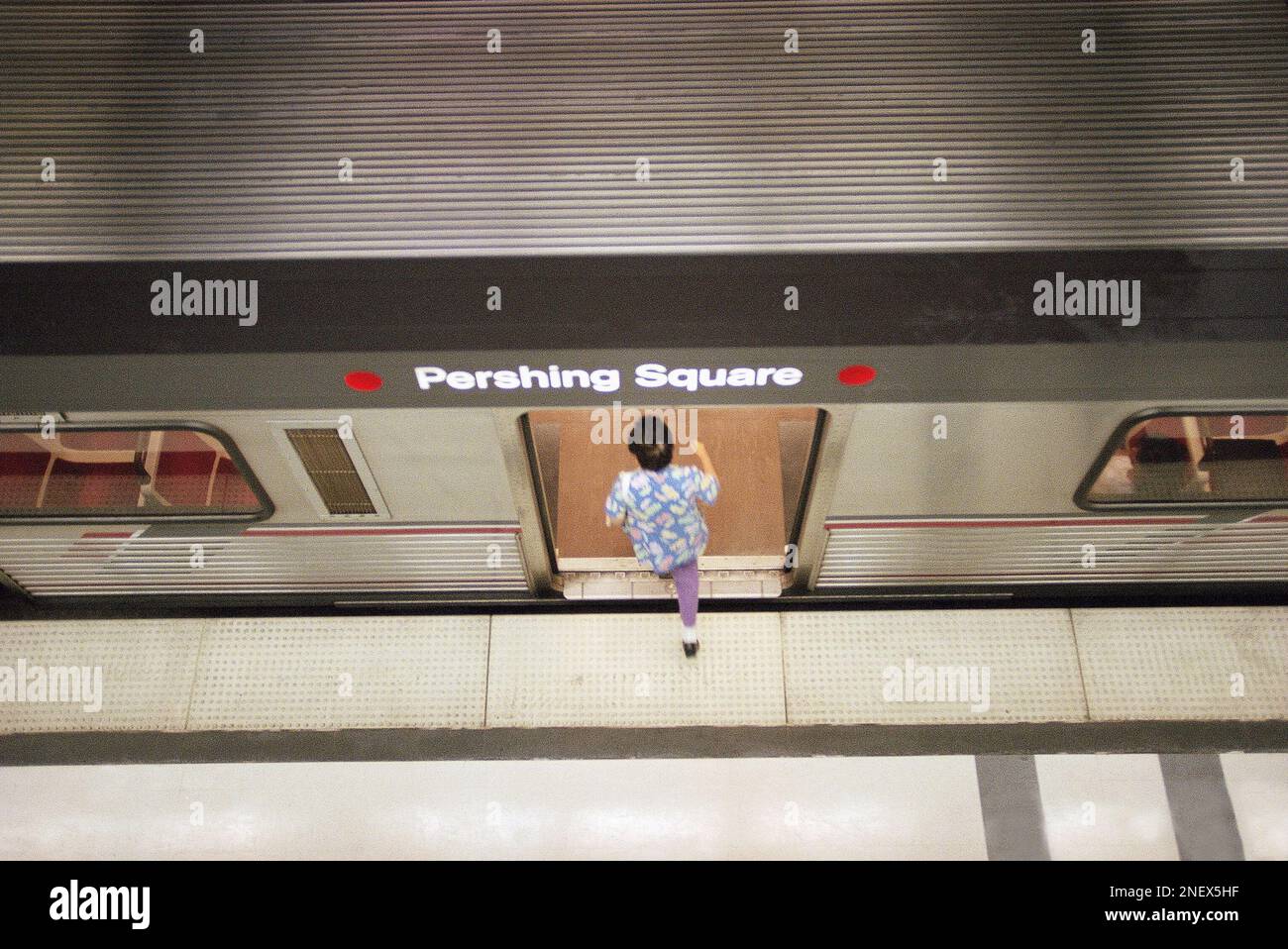 A passenger boards the MTA's red line at Pershing Square in Los Angeles ...