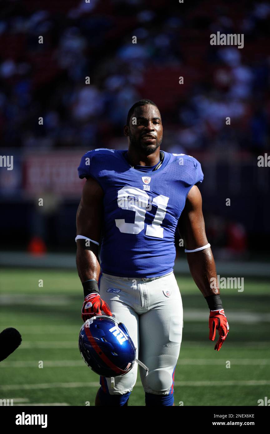 New York Giants defensive end Justin Tuck (91) looks on before a game ...