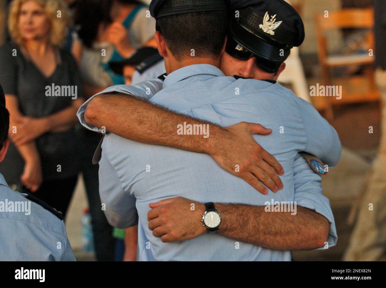 Members of the Israeli air force embrace during the funeral of Capt ...