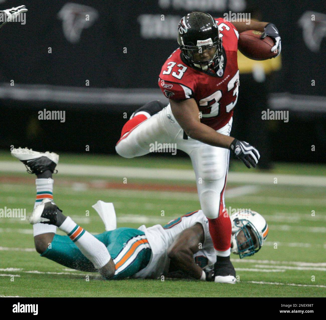 Atlanta Falcons running back Michael Turner (33) goes over Miami ...