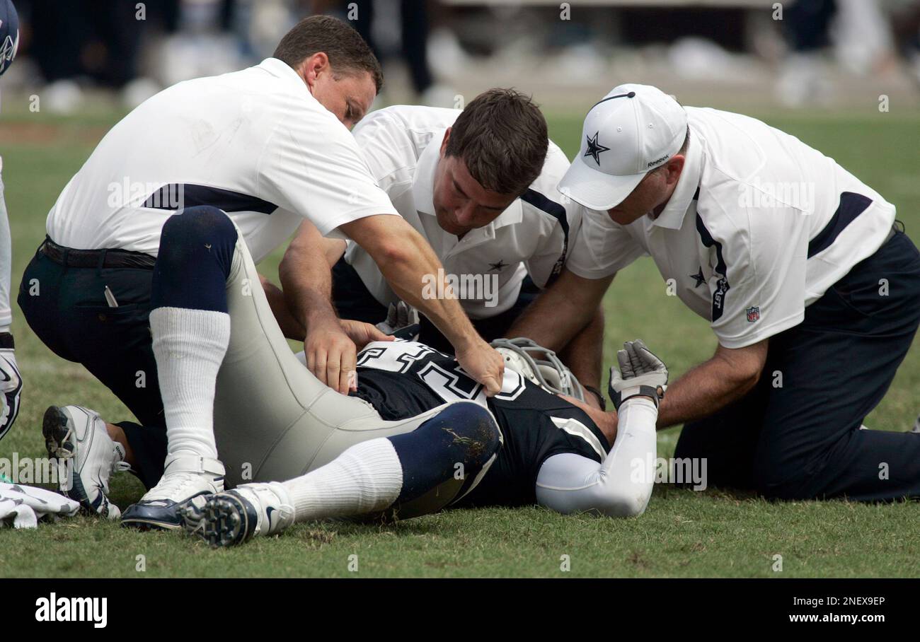 Trainers work on injured Dallas Cowboys safety Gerald Sensabaugh (43 ...