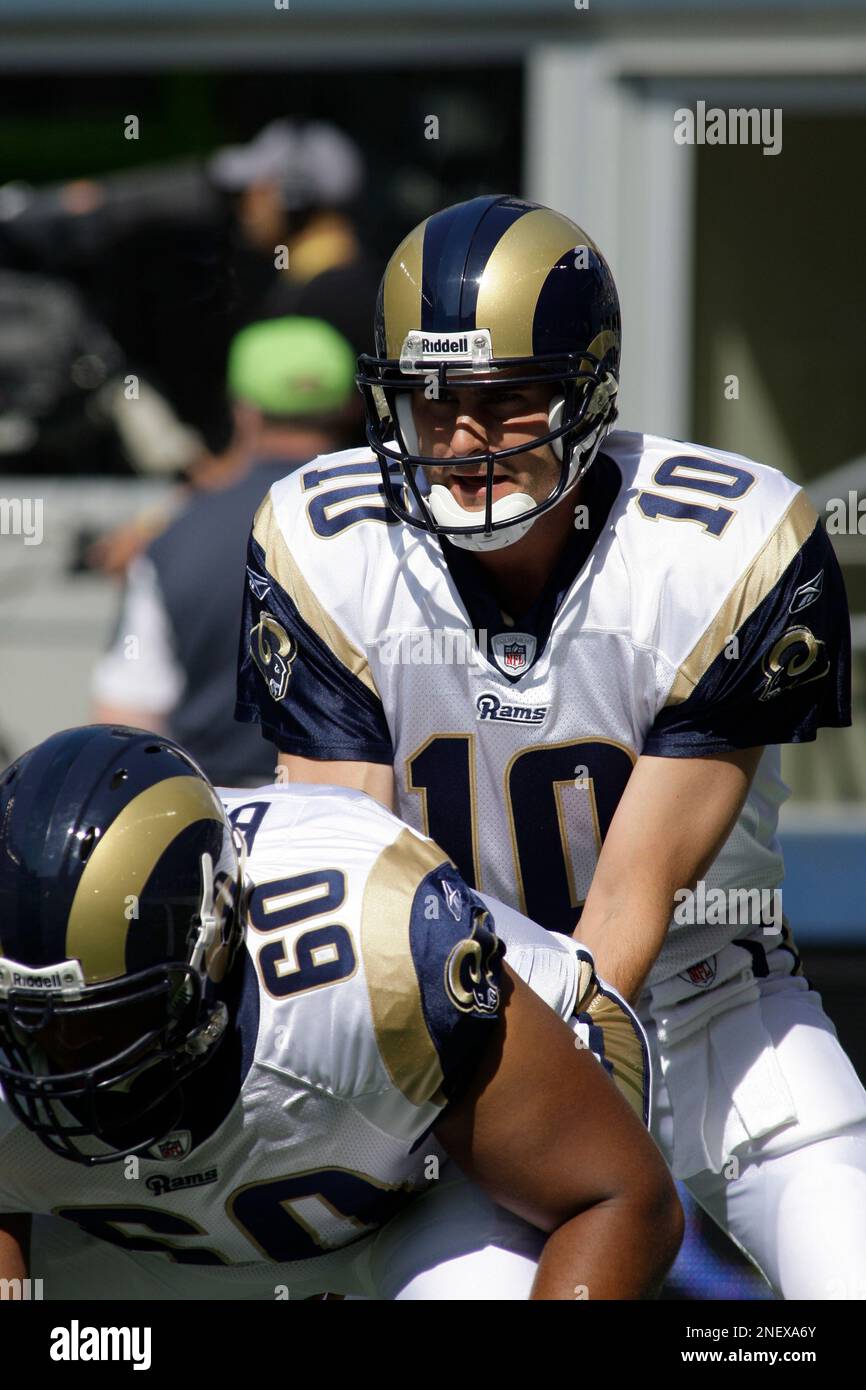 St. Louis Rams quarterback Marc Bulger takes the snap from Jason Brown ...