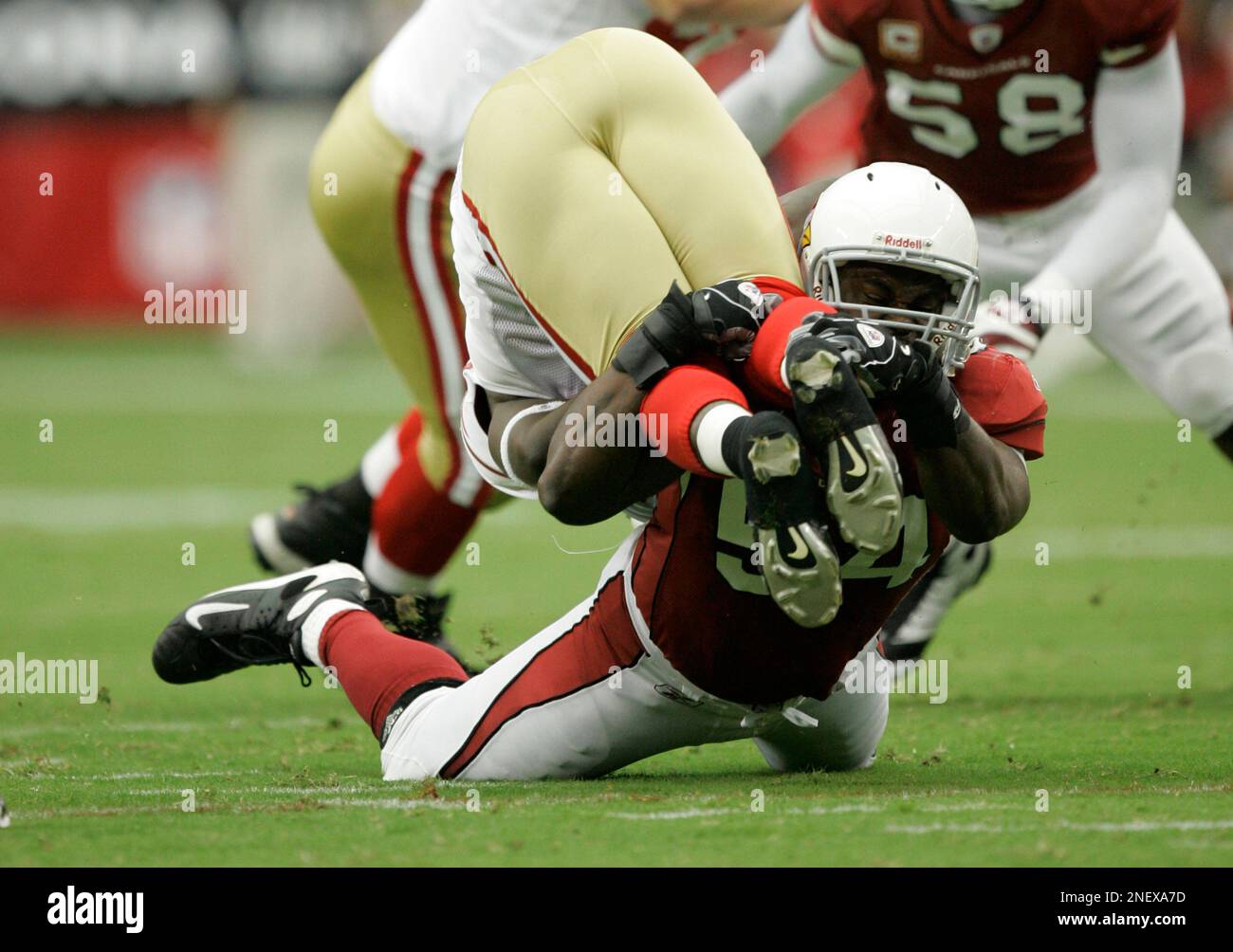Arizona Cardinals linebacker Gerald Hayes, bottom, stops San Francisco ...