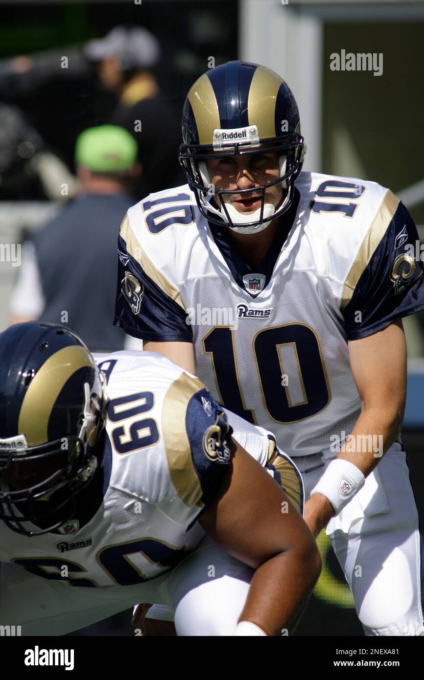 St. Louis Rams quarterback Marc Bulger takes the snap from Jason Brown ...