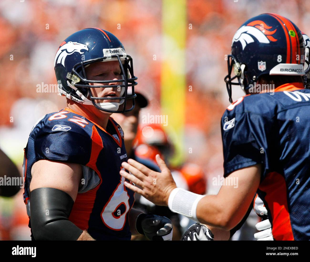 Denver Broncos center Casey Wiegmann (62) listens to instructions from ...