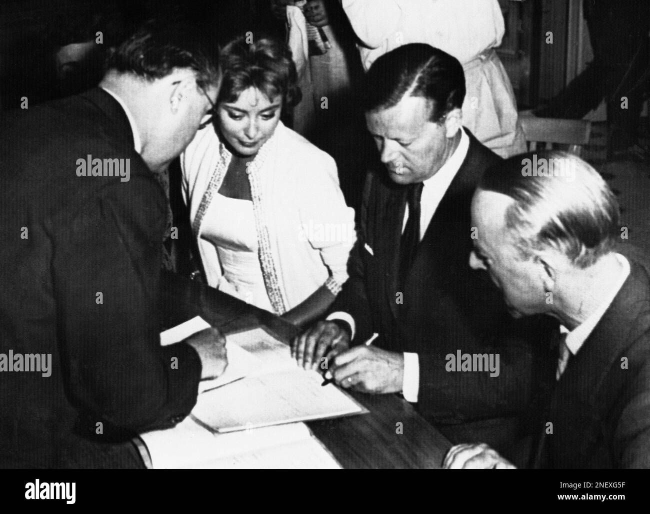 Danish foreign minister Jens Otto Krag signs the marriage register as ...