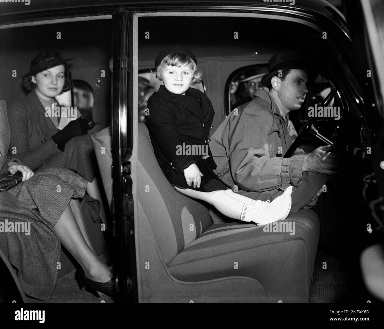 Smilingly, little Manfred Hauptmann perches on the front seat of an ...