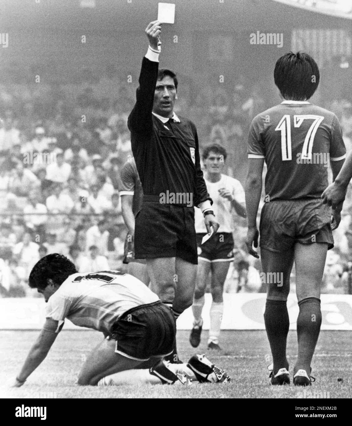Spanish referee Victoriano Sanchez, centre, shows the yellow card to ...