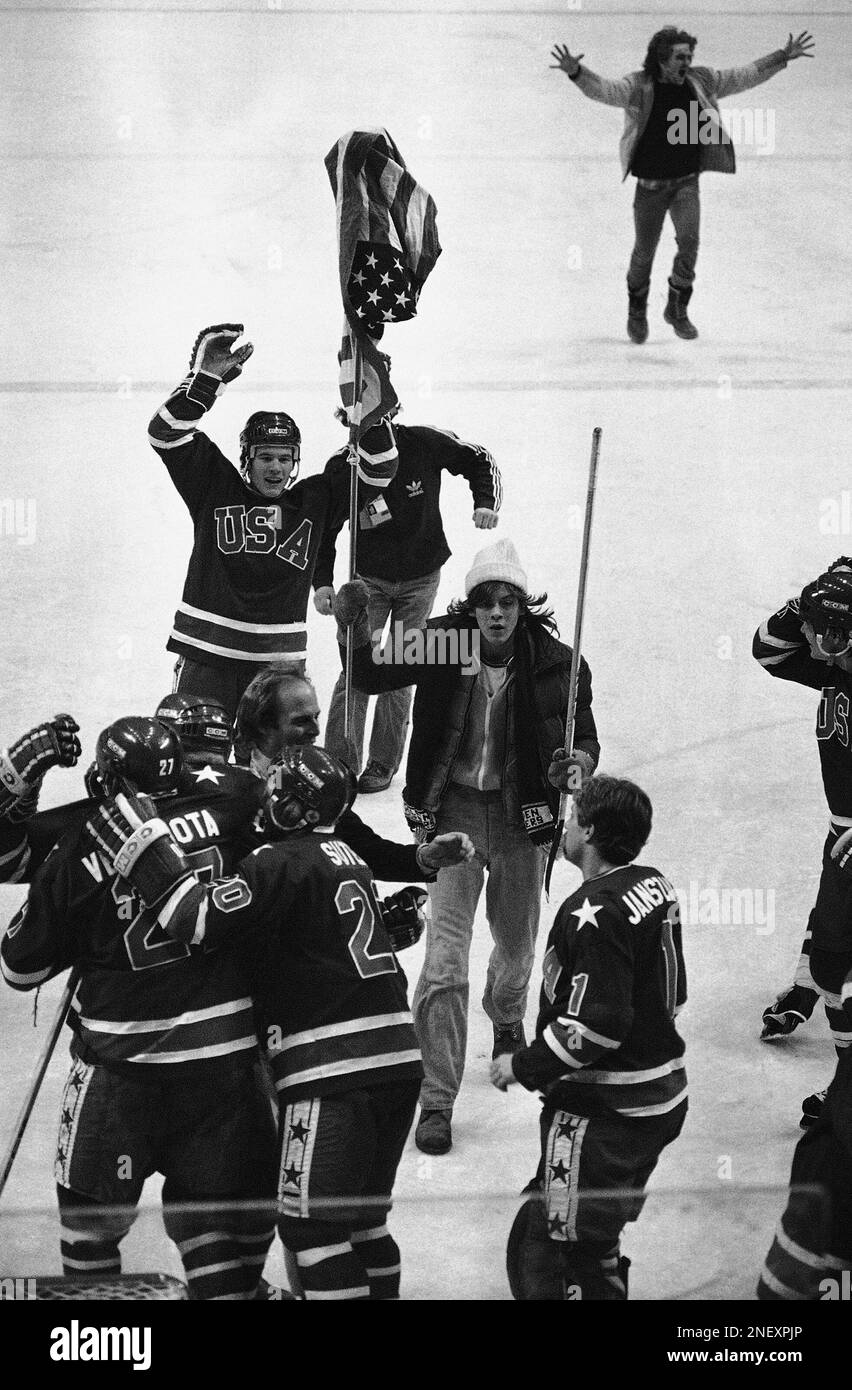 Craig Patrick, USA assistant hockey coach, a hugged by three team ...