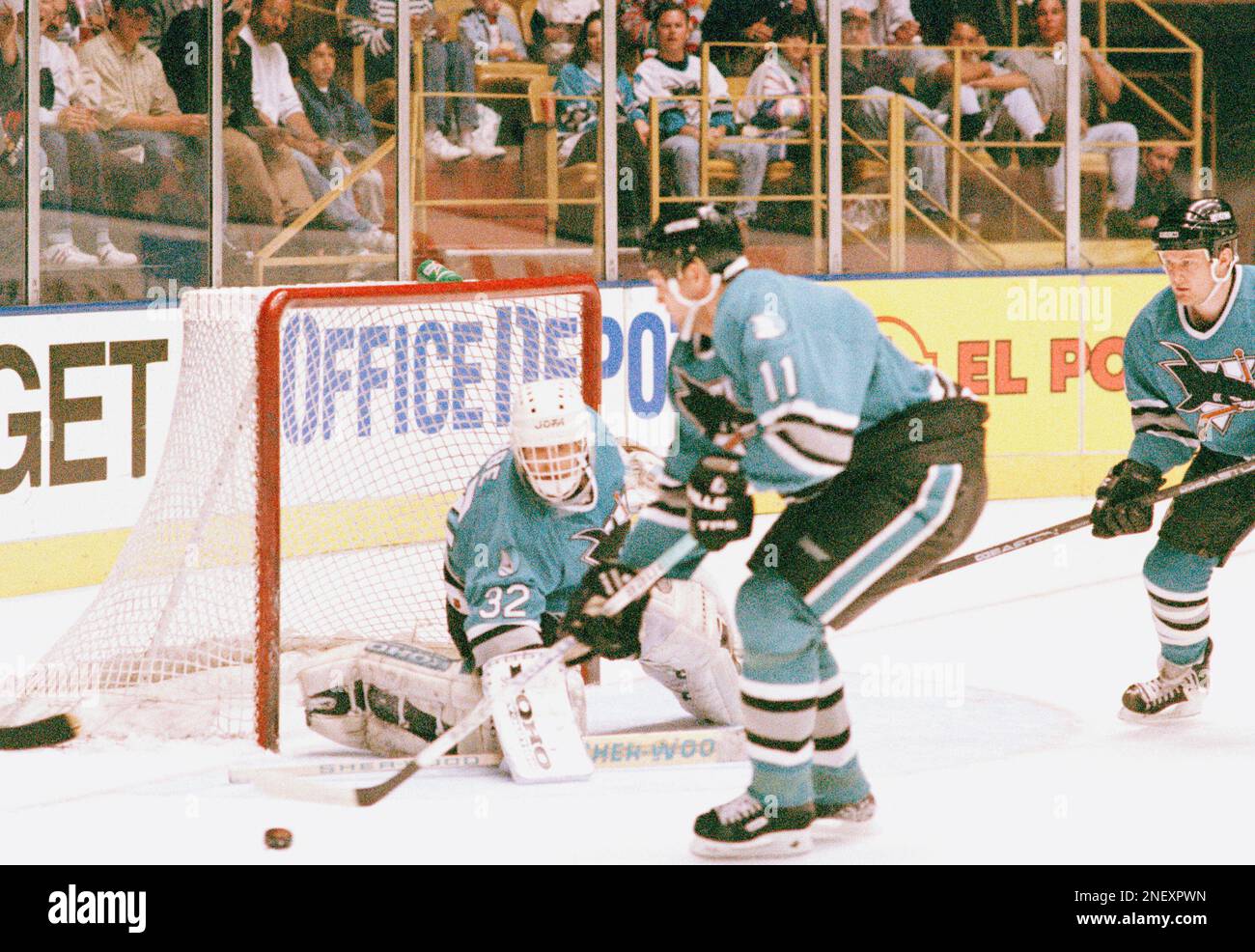 San Jose Sharks’ Owen Nolan (11) helps out goalie Arturs Irbe to tharwt ...