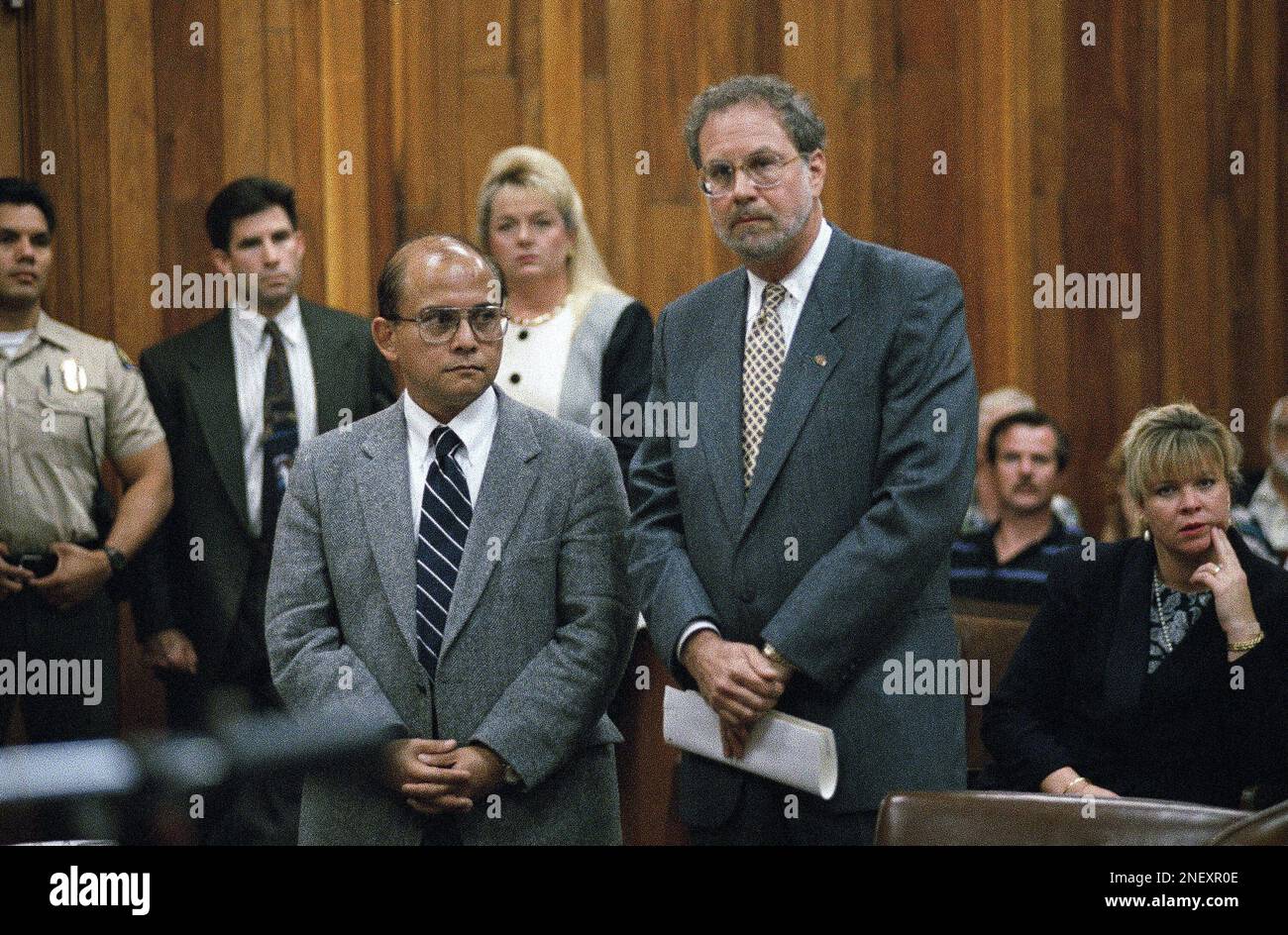 Accused child molester, Rev. Ted Llanos, left, faces a judge, Nov. 29 ...